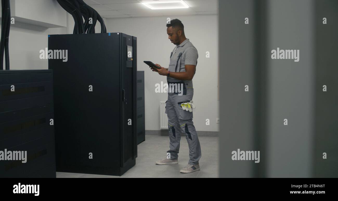 Professional engineer in safety uniform uses digital tablet computer to ...