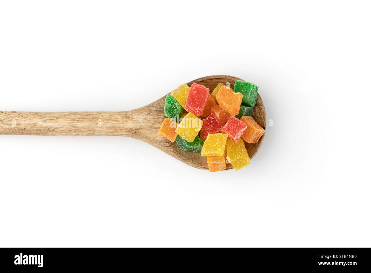 diced candied fruits in wooden spoon isolated on white, peel of oranges ...