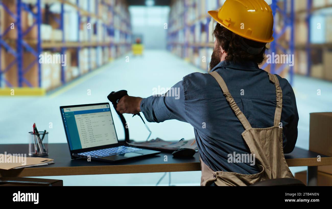 Distribution operations manager works with barcode reader to ensure ...