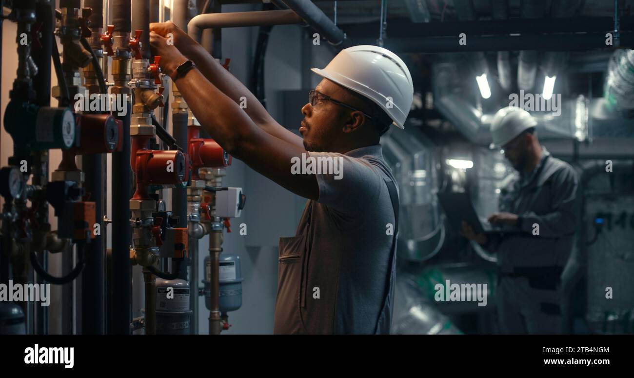 African American heavy industry worker wearing safety uniform and hard ...