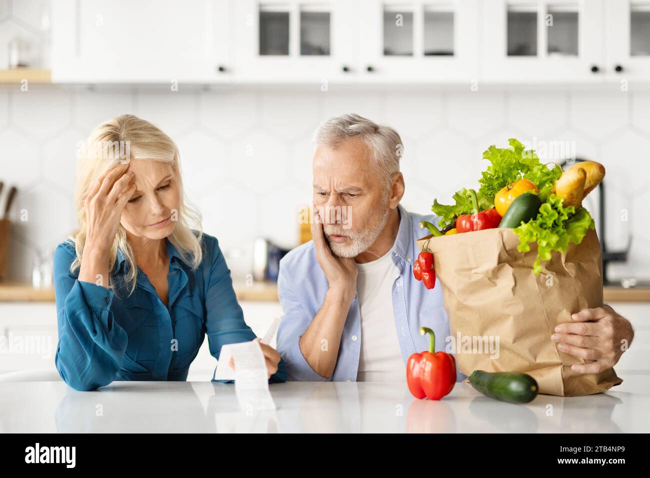 Concerned senior couple examining grocery bill after food shopping Stock Photo - Alamy