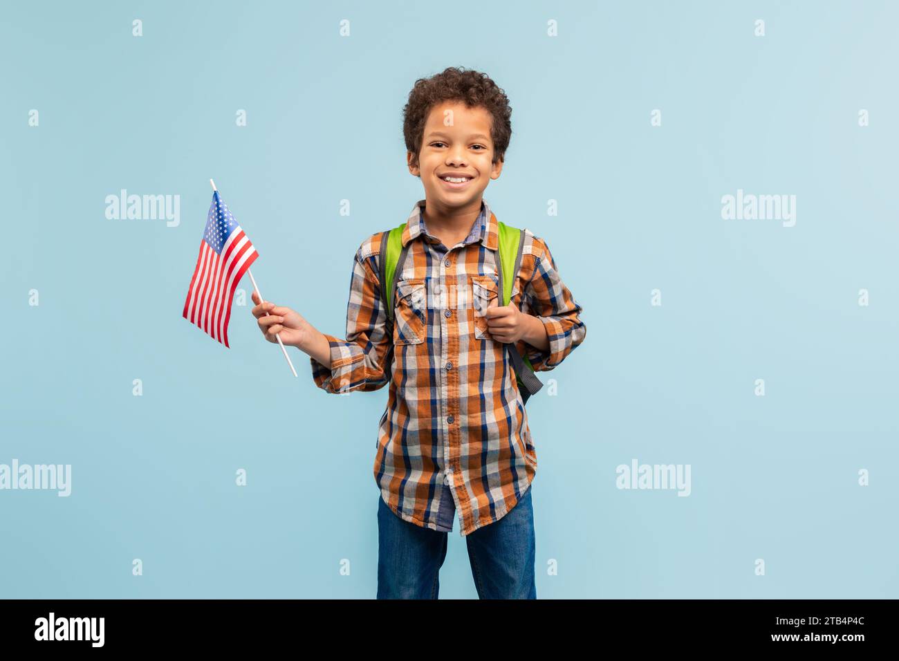 Patriotic boy with flag, plaid shirt, smiling Stock Photo - Alamy
