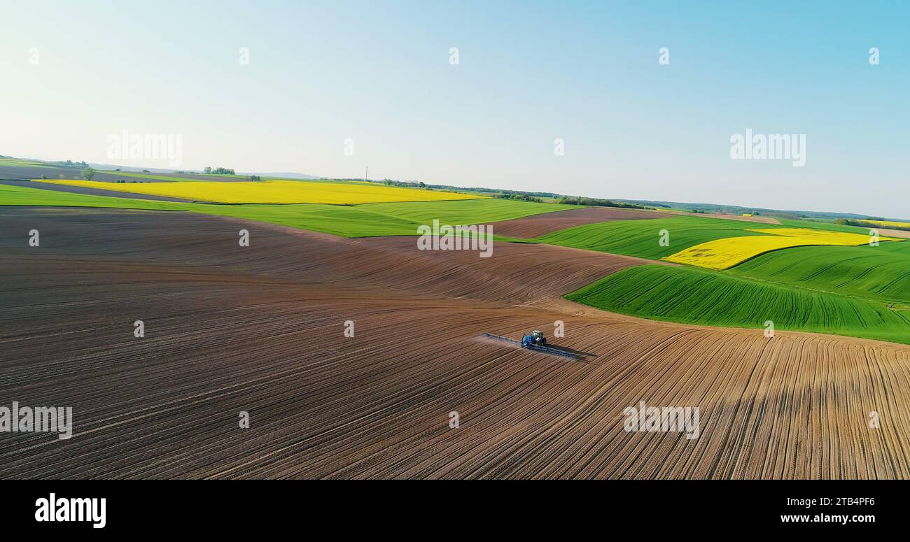 Agricultural - Farmer spraying field Stock Photo - Alamy