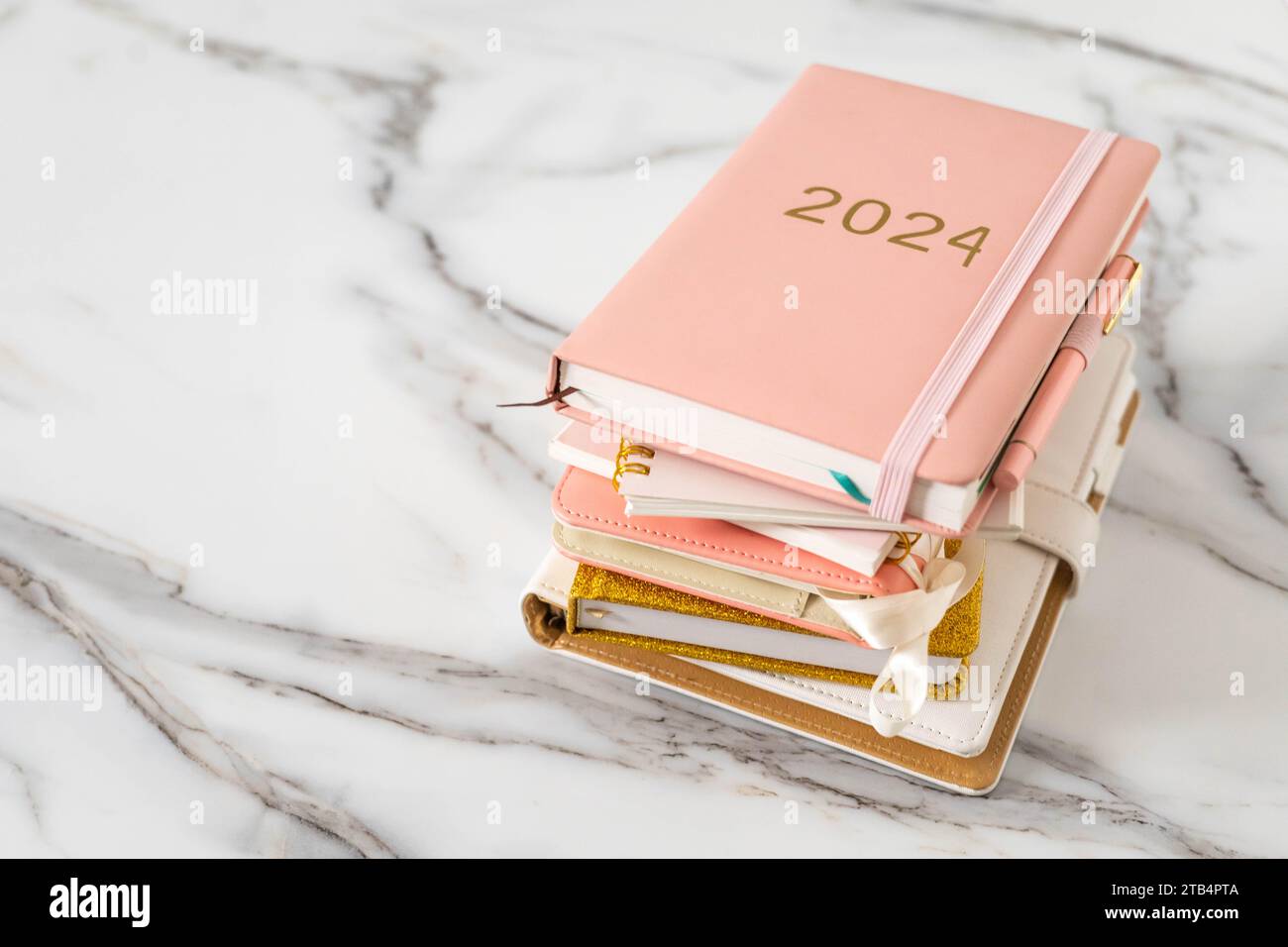 Pink coral colored diary for the year 2024 and many other diaries, pen ...