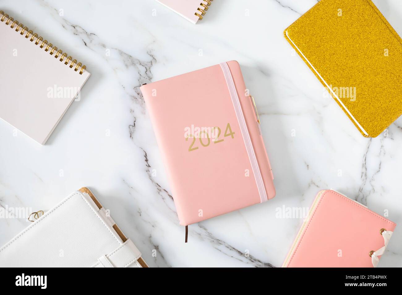 Pink coral colored diary for the year 2024 and many other diaries, pen ...