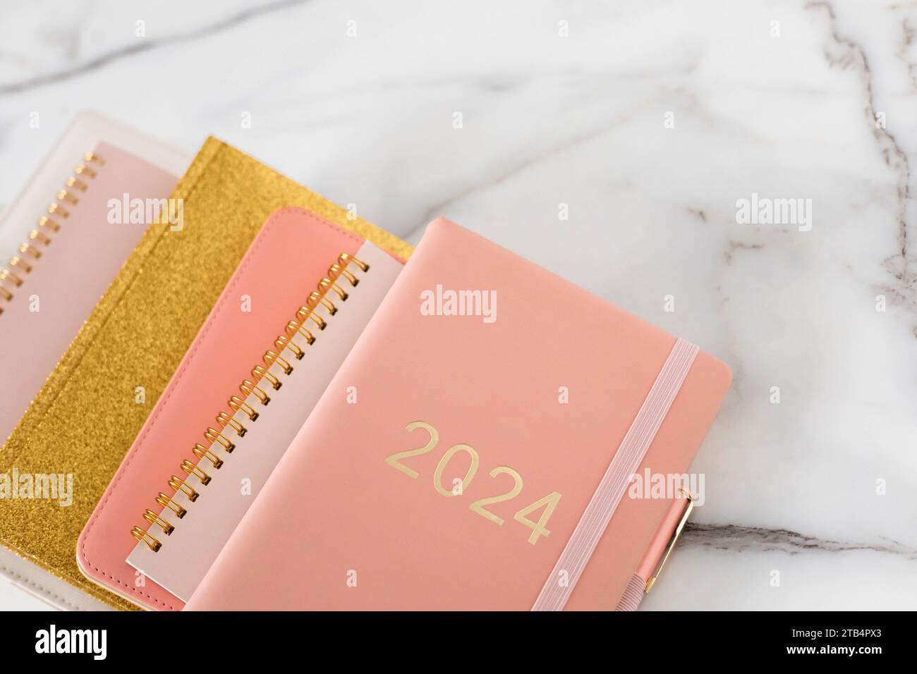 Pink coral colored diary for the year 2024 and many other diaries, pen ...