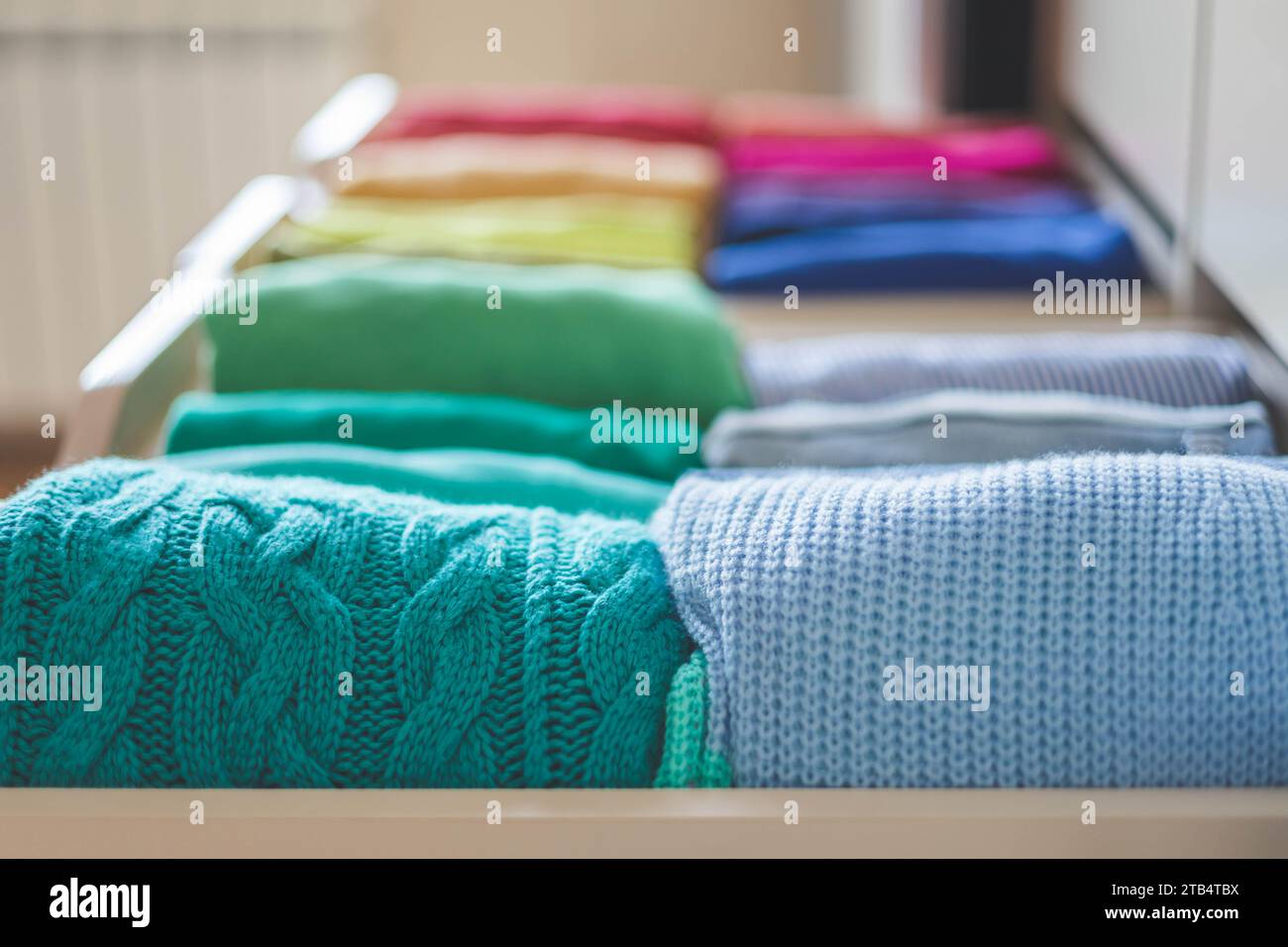 Concept of beautiful and comfortable organization. Rainbow clothes are ...