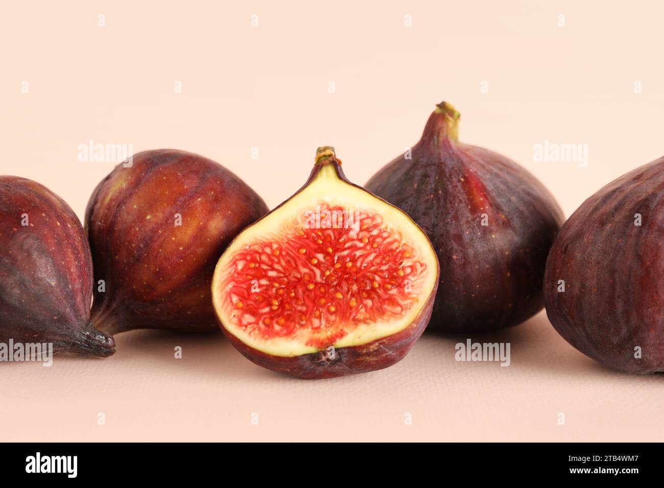 Fresh juicy cut figs on pale pink background Stock Photo - Alamy