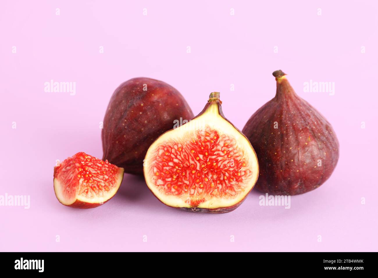 Fresh juicy cut figs on lilac background Stock Photo - Alamy