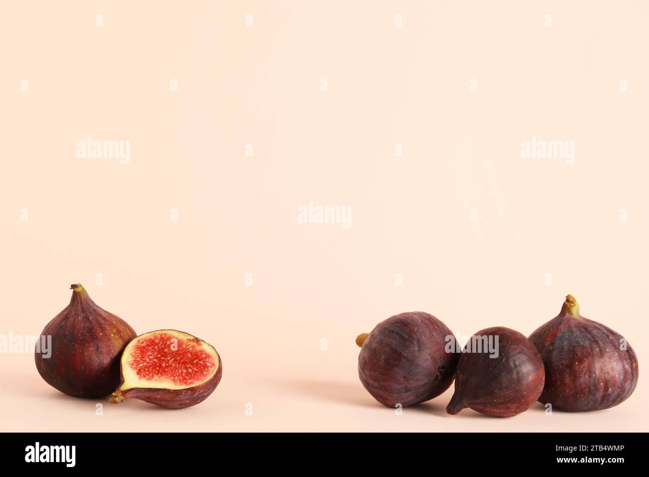 Fresh juicy cut figs on pale pink background Stock Photo - Alamy