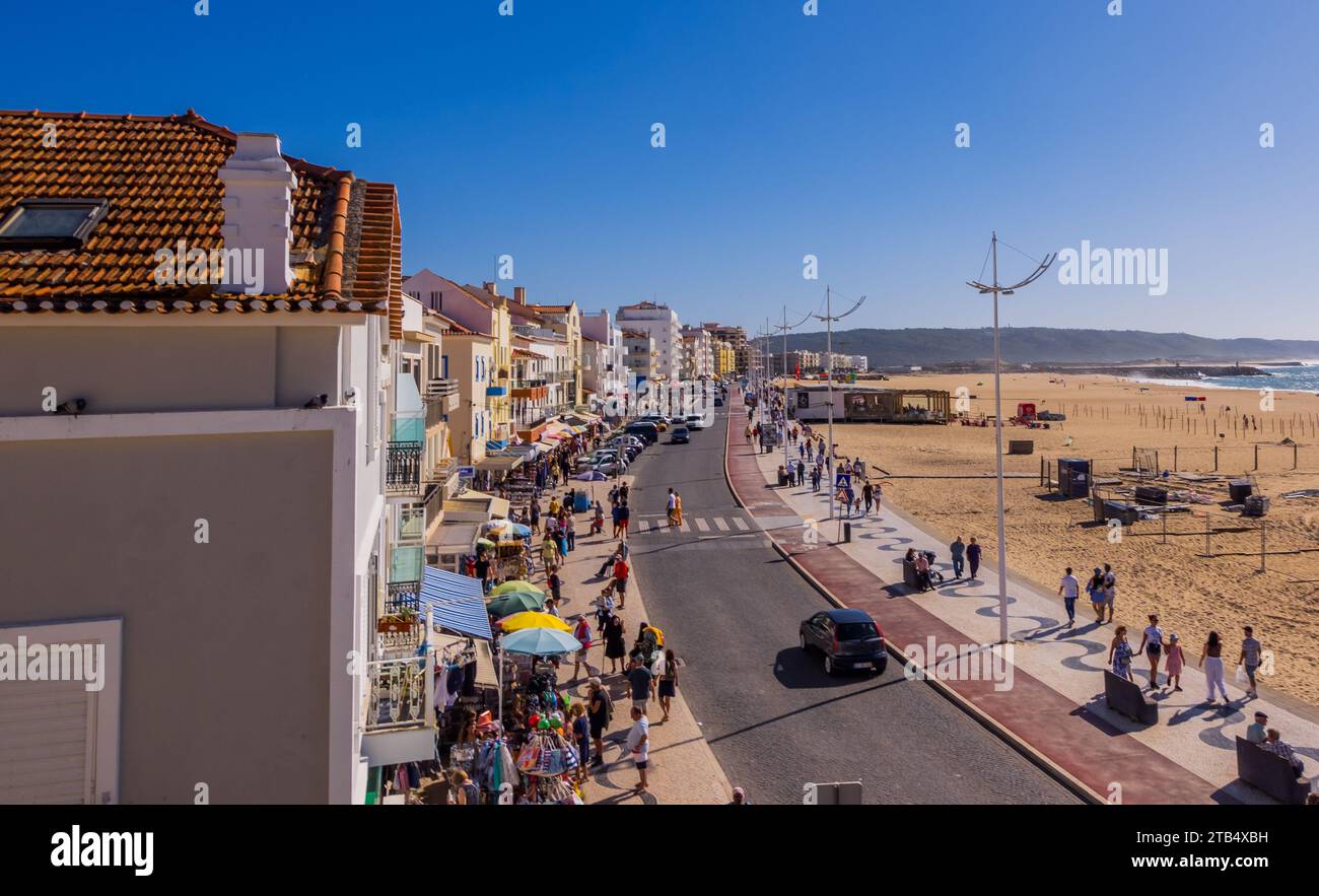 the main beach promenade with shops at sunset in Nazare, Portugal Stock ...