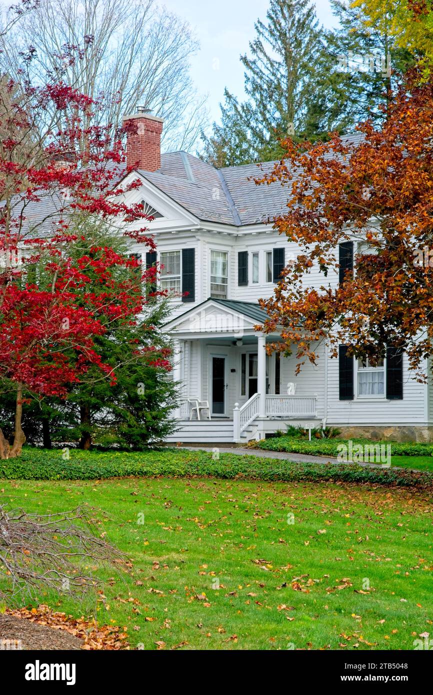 Colonial home shrouded in autumn colored trees on Main Street ...
