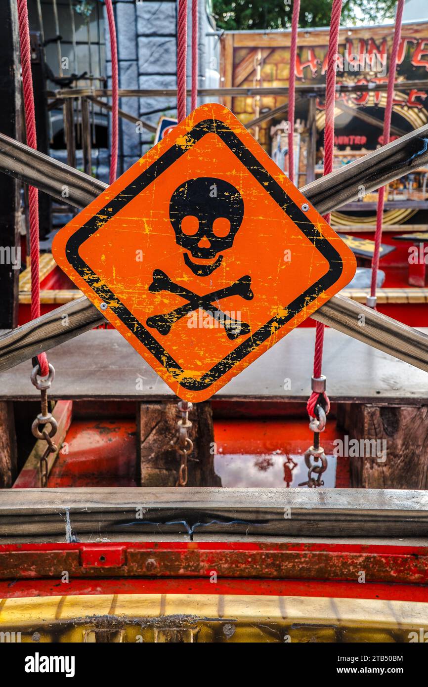 Hanging metal sign toxic with scull and bones over orange Stock Photo ...