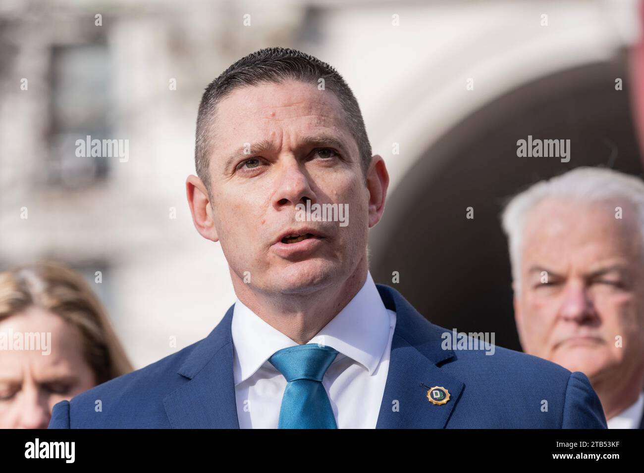 Assistant Chief Jason Savino speaks as Senator Kirsten Gillibrand ...