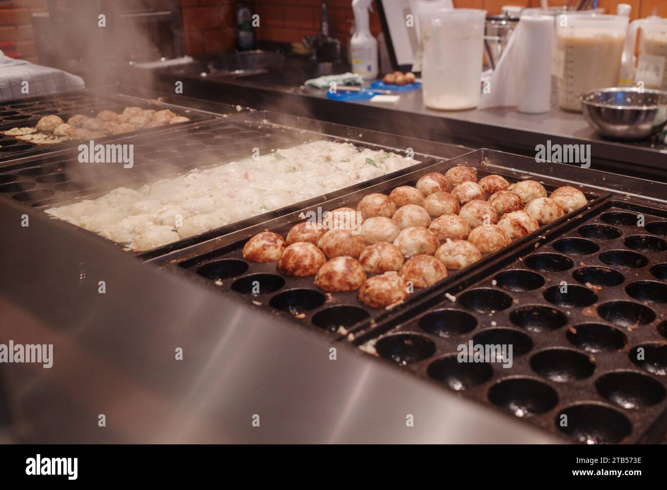 Selective focus at Takoyaki, ball-shaped Japanese snack made of a wheat ...