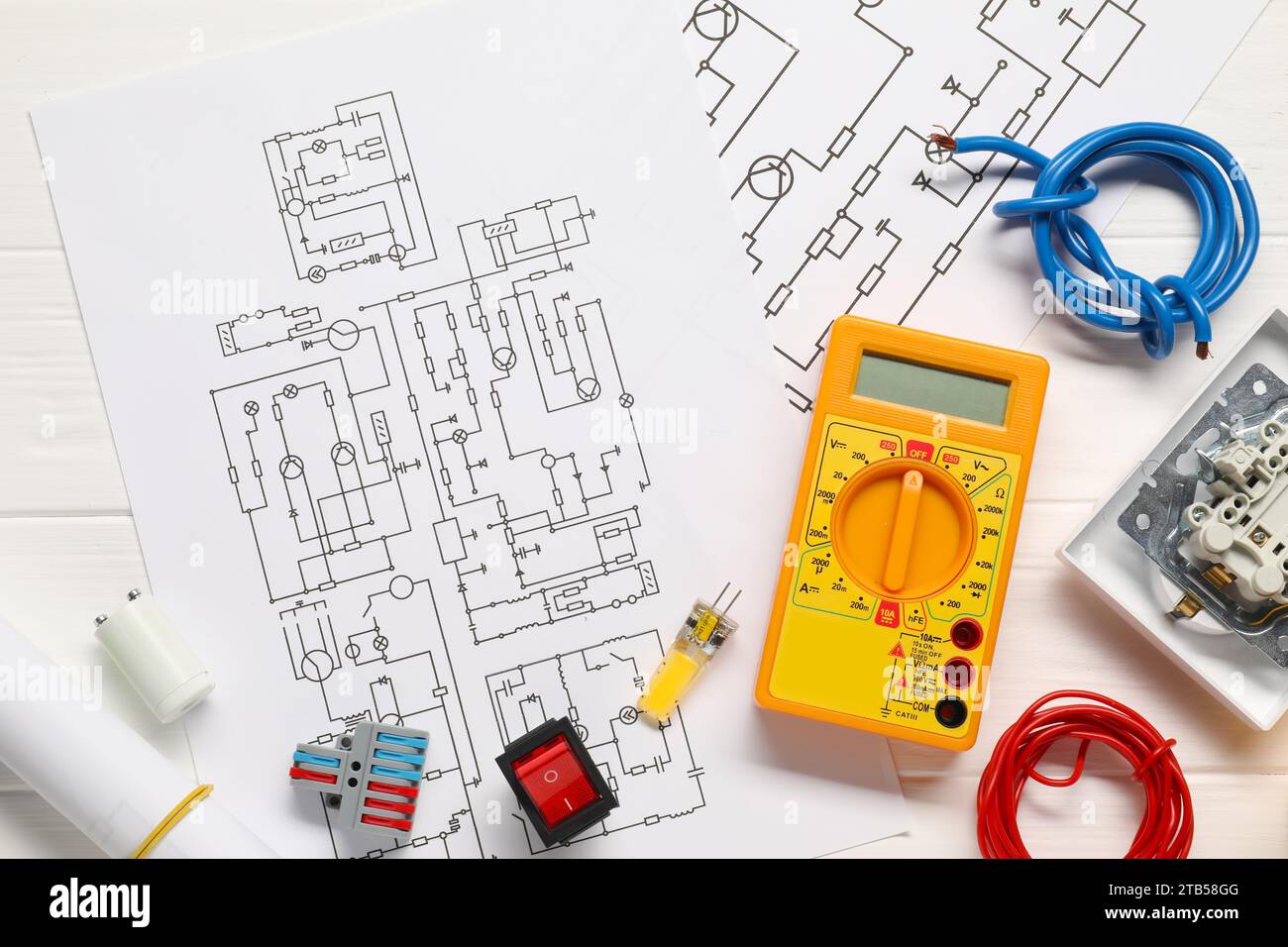 Flat lay composition with wiring diagrams and digital multimeter on ...