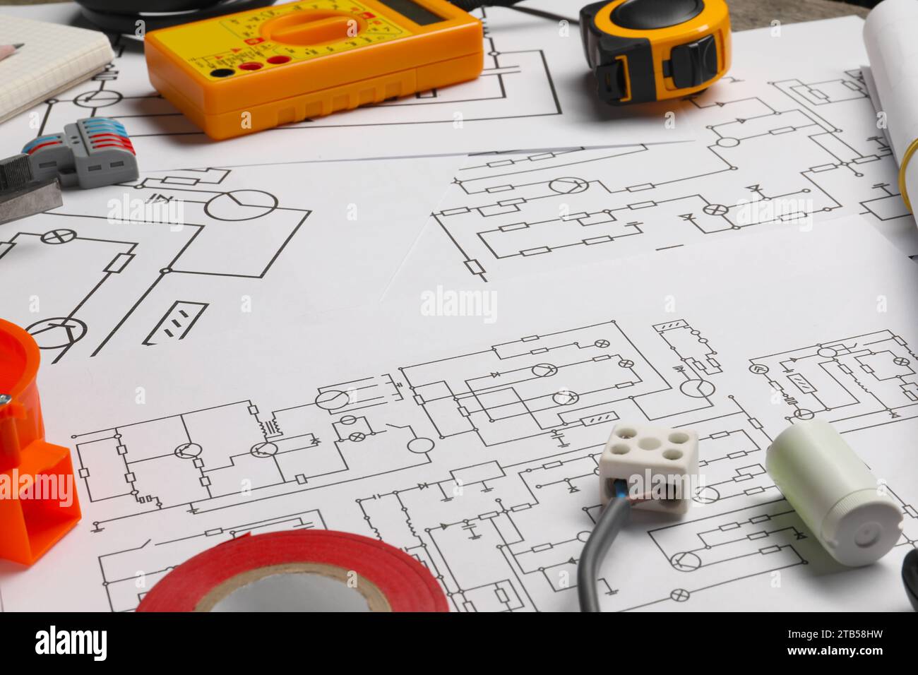 Digital multimeter and other electrician's equipment on wiring diagrams ...