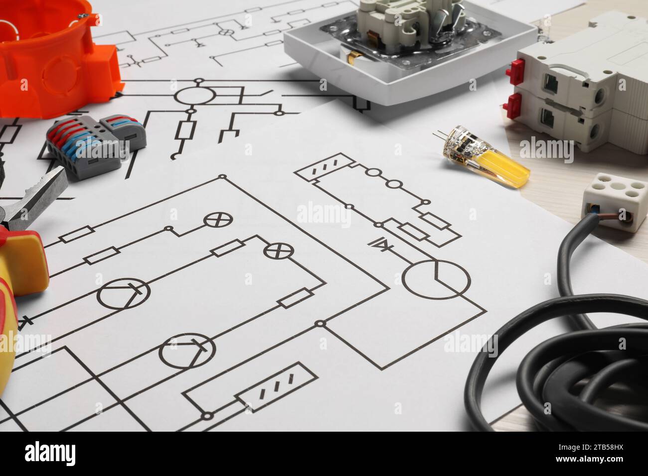 Wiring diagrams and different electrician's equipment on white table ...