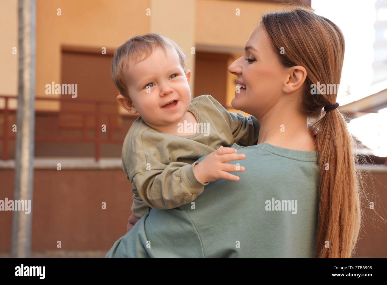 Happy nanny with cute little boy outdoors Stock Photo - Alamy