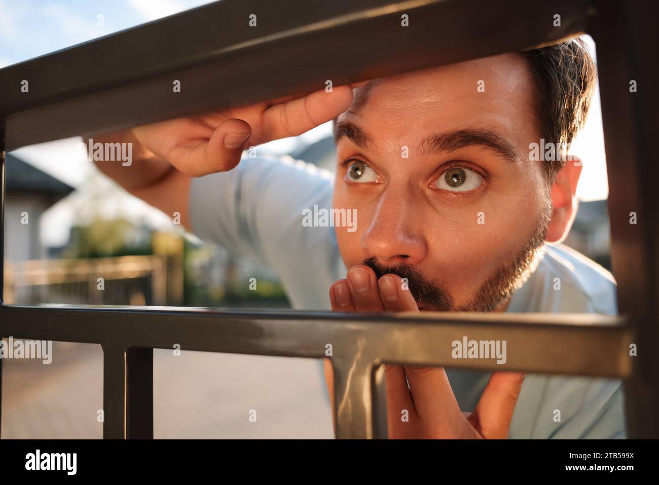 Man watching over fence hi-res stock photography and images - Alamy