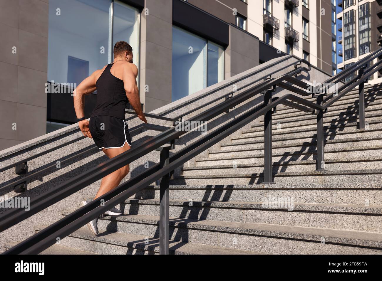 Man running up stairs outdoors on sunny day Stock Photo - Alamy
