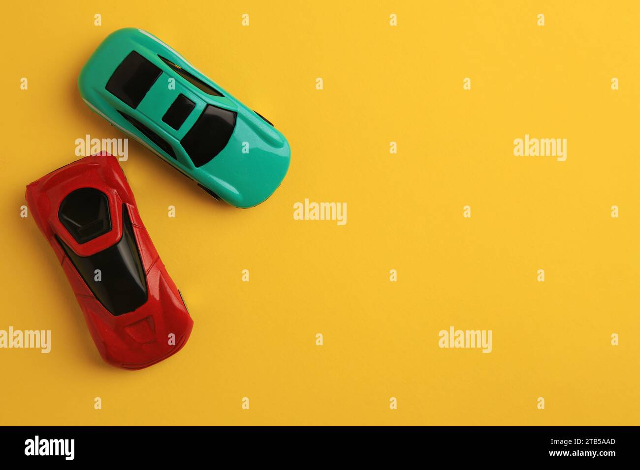 Bright cars on yellow background, flat lay with space for text ...