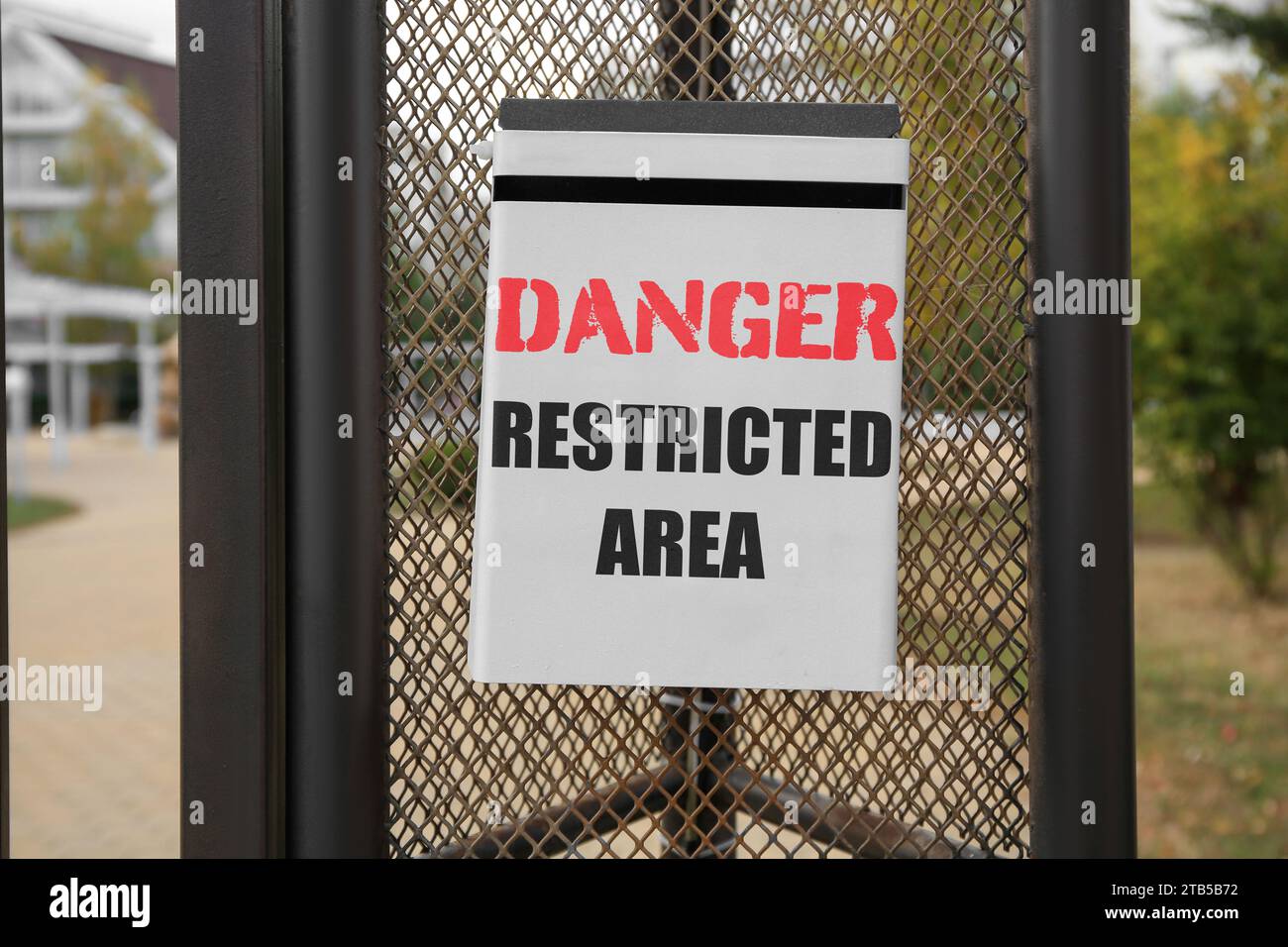 Sign with text Danger Restricted Area on fence outdoors Stock Photo - Alamy