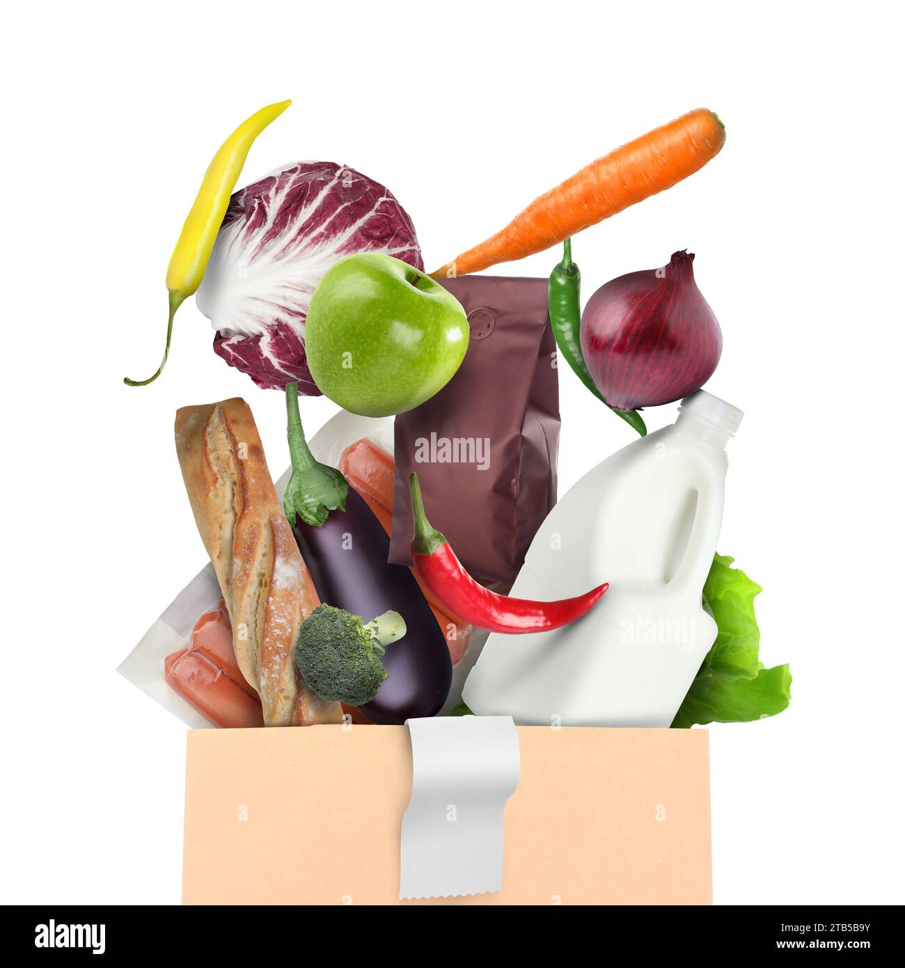 Different food products falling into paper bag on white background ...