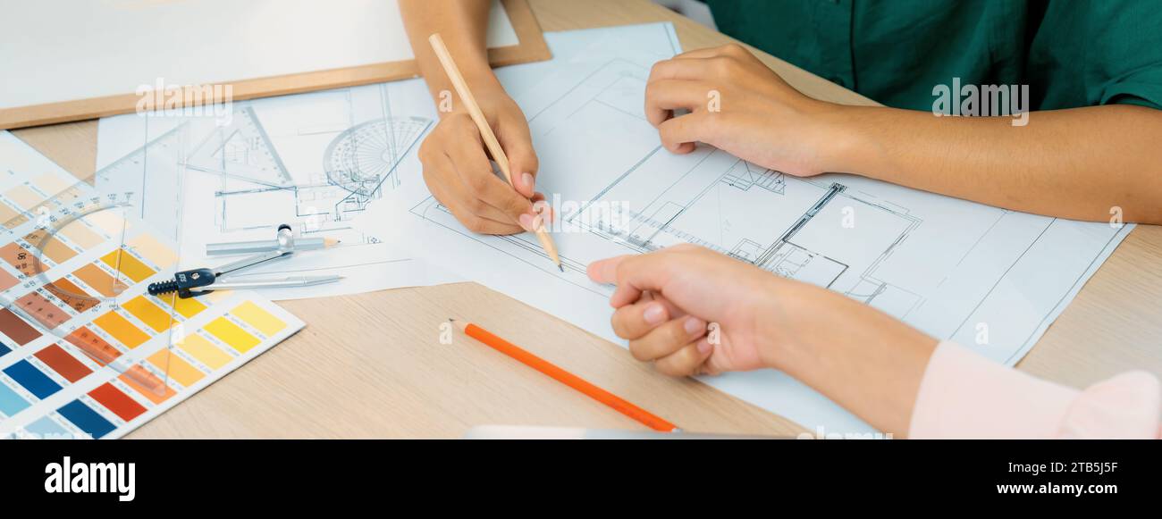 Professional architect drafts blueprint from project manager advice on ...