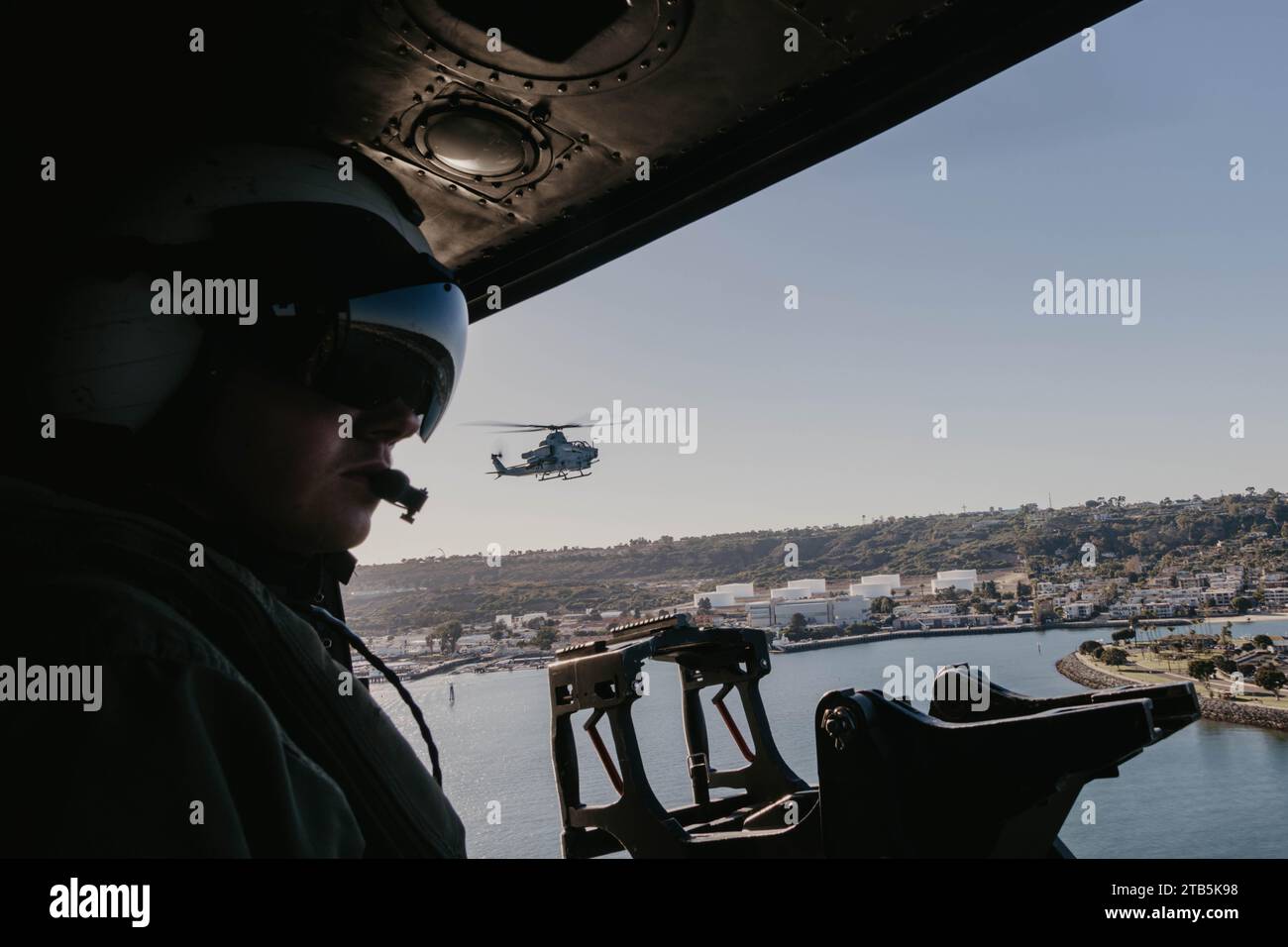 A U.S. Marine with 3rd Marine Aircraft Wing observes a AH-1Z Viper ...