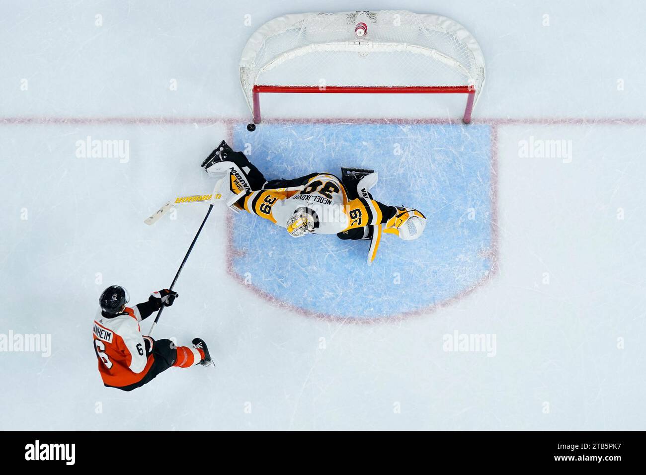 Pittsburgh Penguins' Alex Nedeljkovic, right, deflects a shot by ...