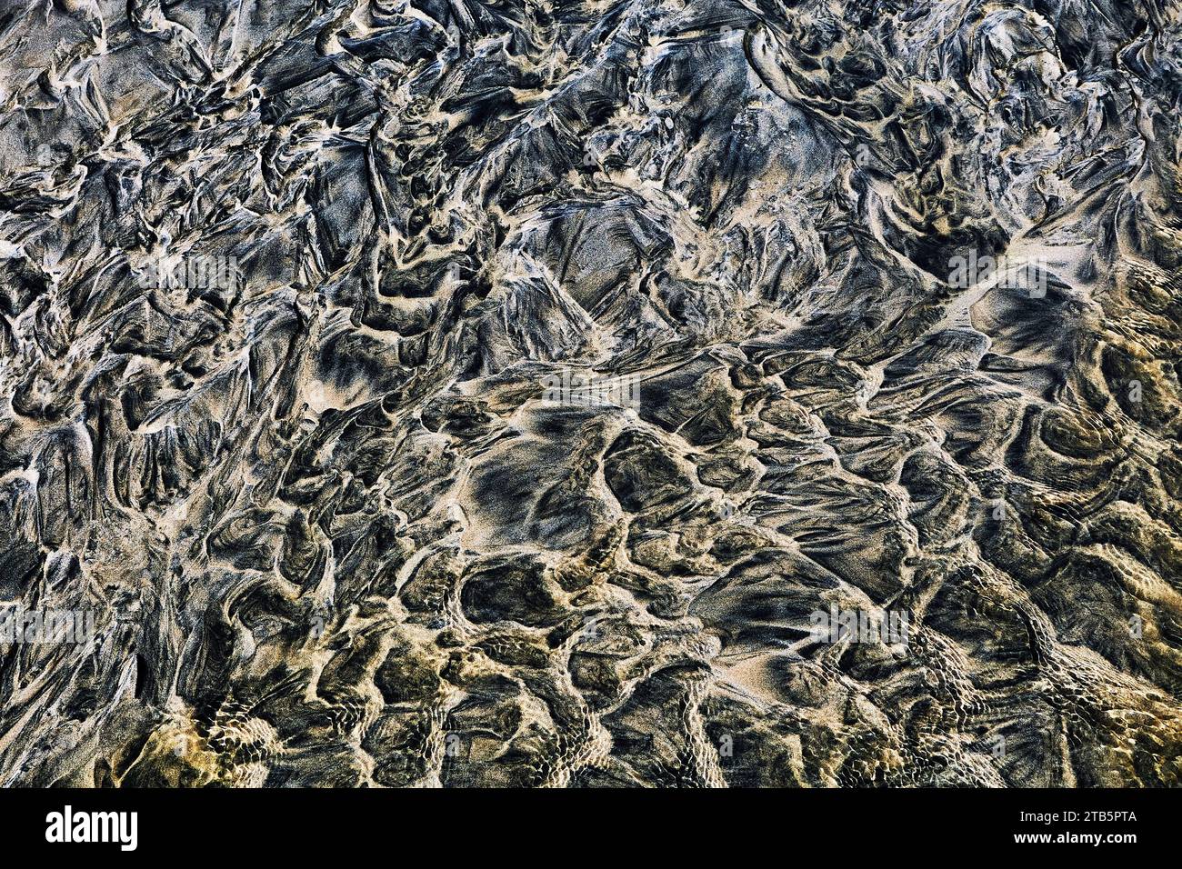 Wet sand and water strange, dark, abstract patterns Stock Photo - Alamy