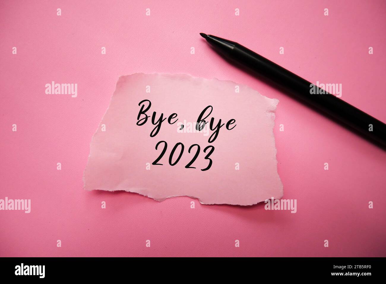 hand holding paper with the words BYE, BYE 2023 on a piece of note ...