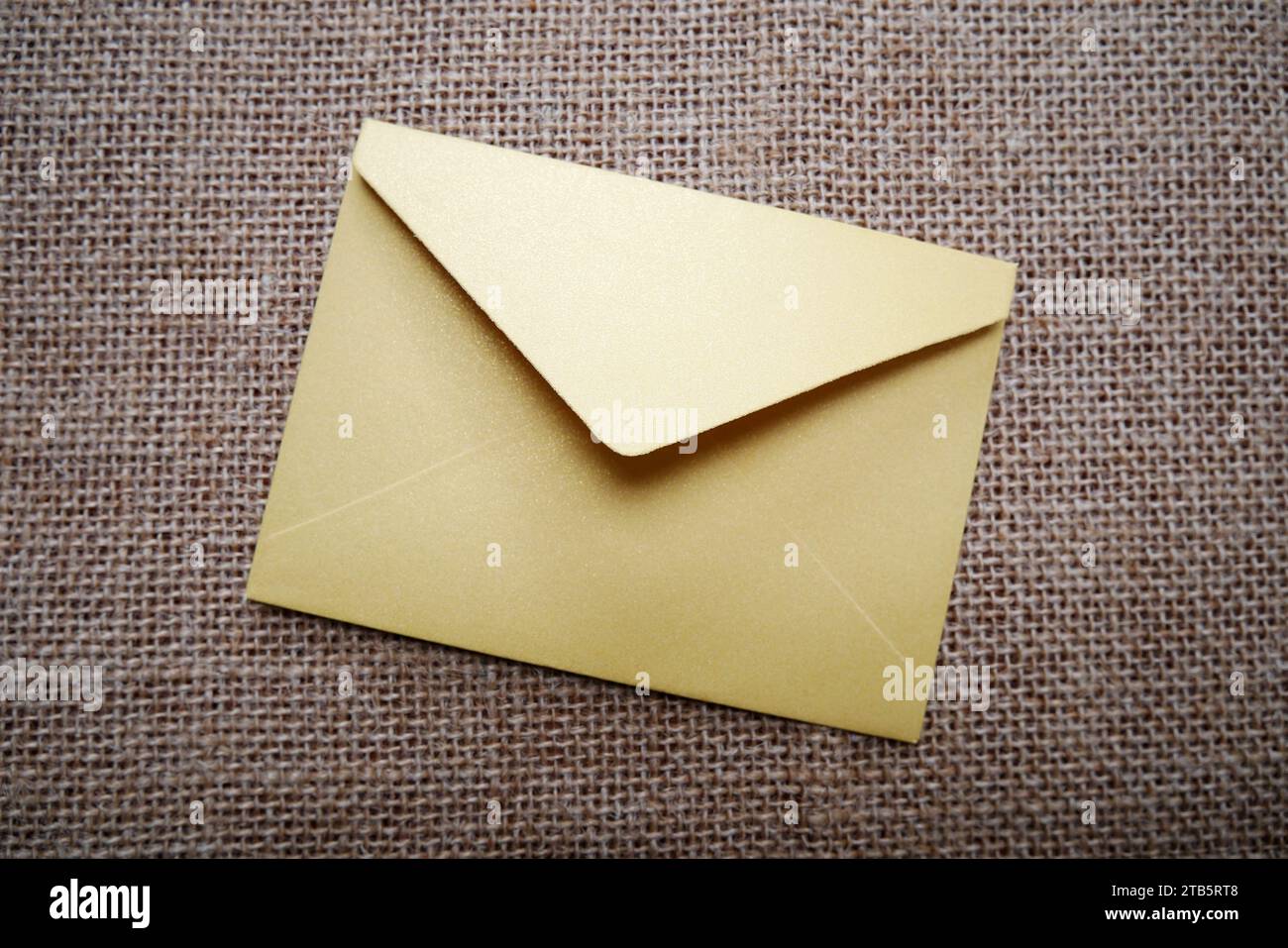 blank envelope on burlap background Stock Photo - Alamy