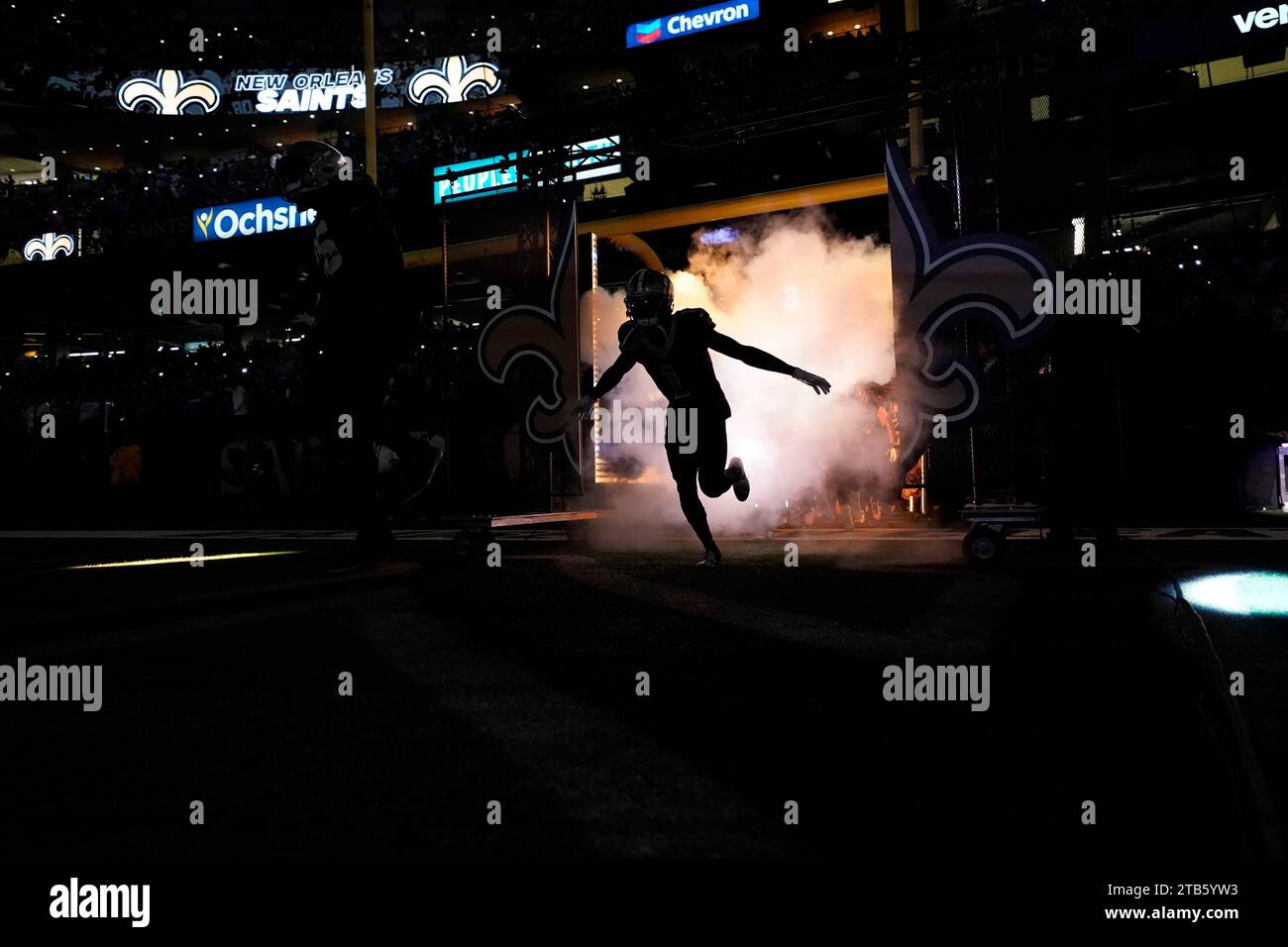 New Orleans Saints run onto the field before an NFL football game ...