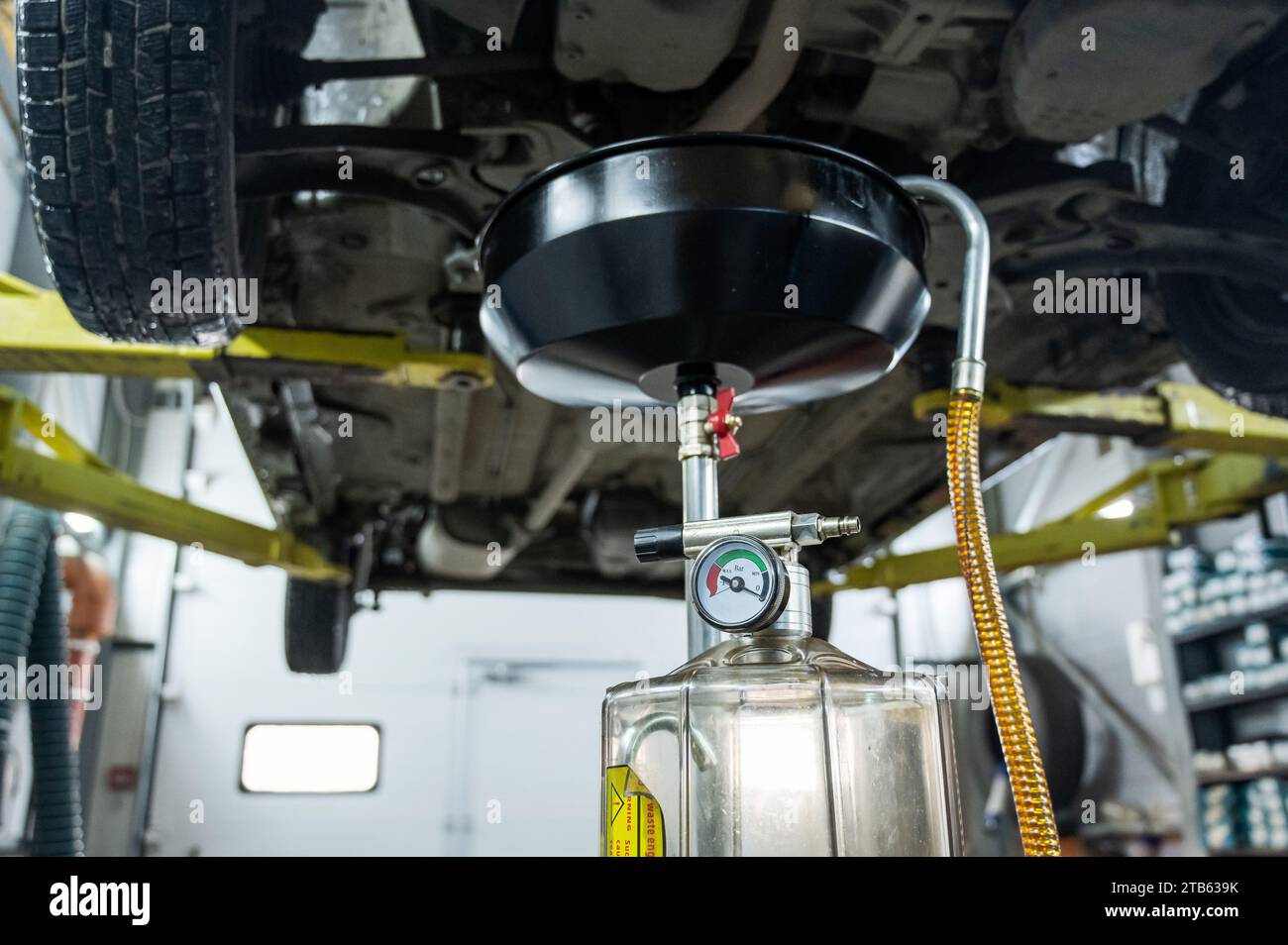 The process of changing the oil in a car engine. Draining old dark used ...
