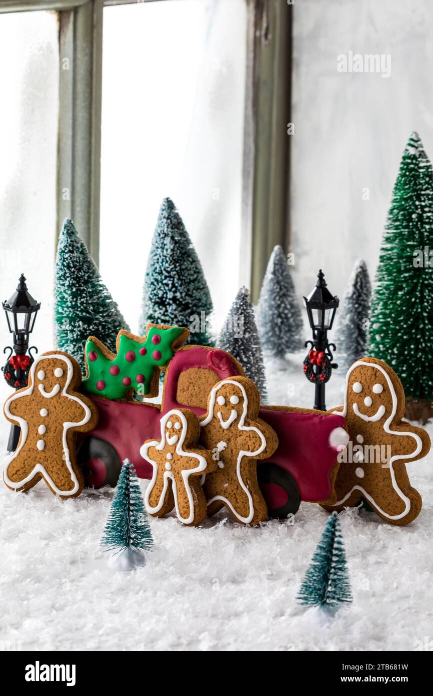 A gingerbread cookie family harvesting a tree for the holidays Stock ...