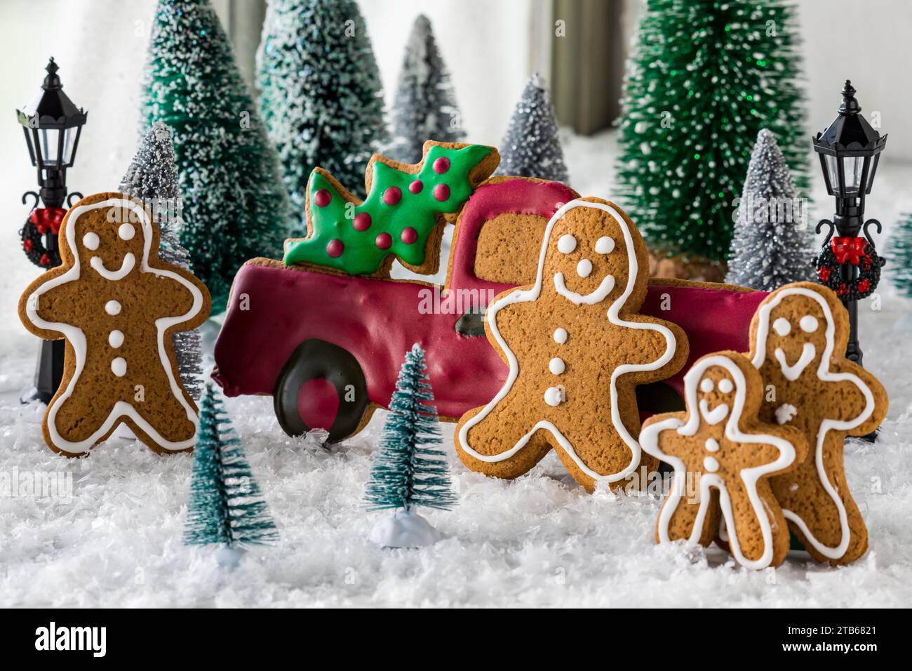 A gingerbread family harvesting a tree for the holidays. Select focus ...