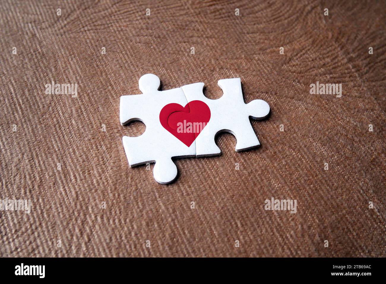 Puzzle pieces that make up a heart on the yellow background. The ...