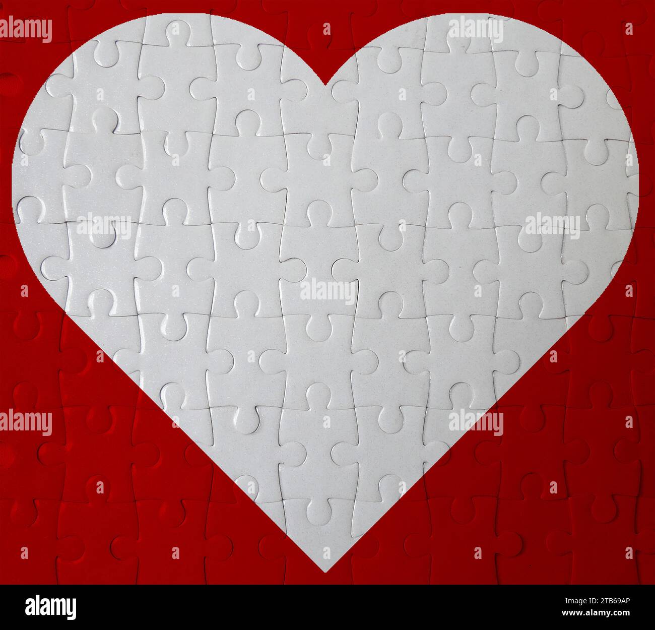 Puzzle pieces that make up a heart on the yellow background. The ...