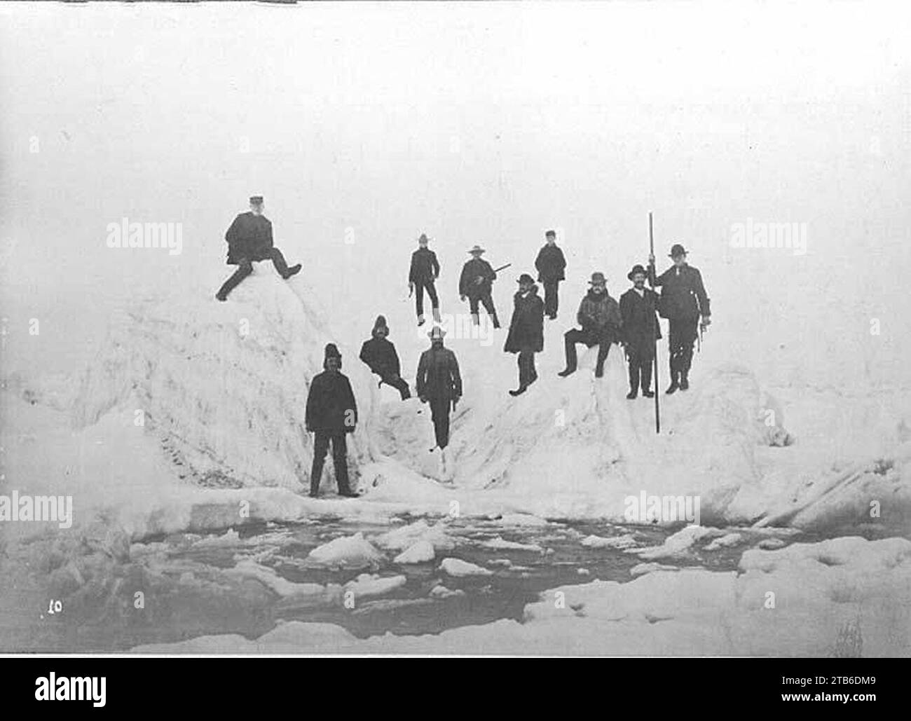 Walrus hunters with guns gathered around an iceberg, Alaska, circa 1906 ...