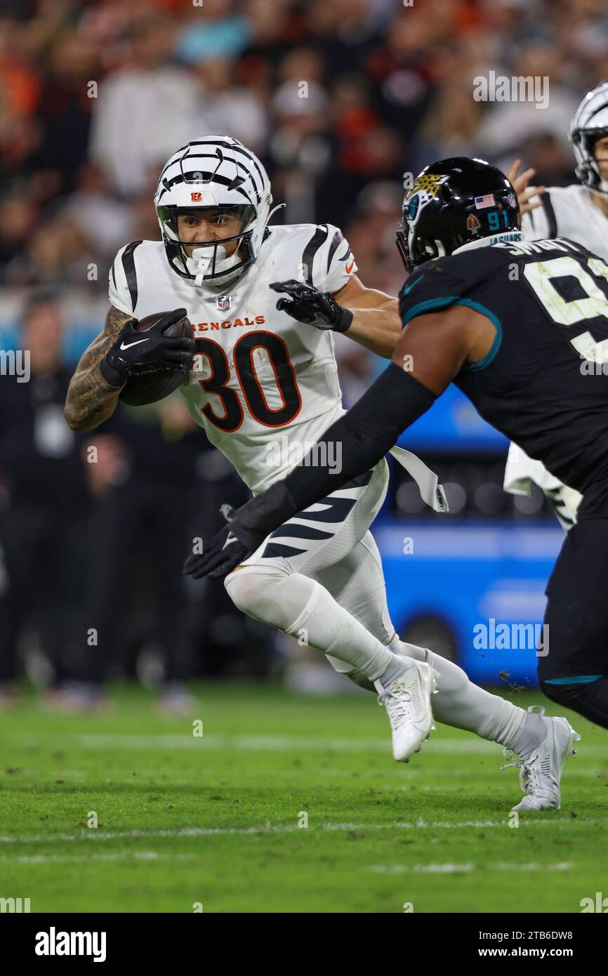 Cincinnati Bengals running back Chase Brown (30) runs the ball pursued ...