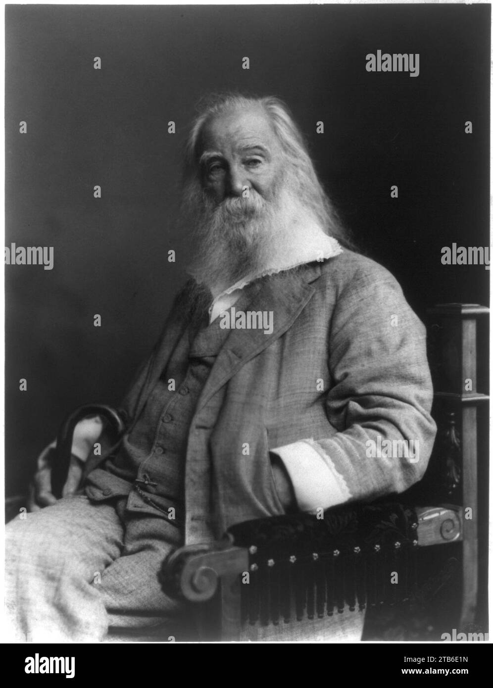 Walt Whitman, 1819-1892, three-quarters length portrait, seated, facing ...