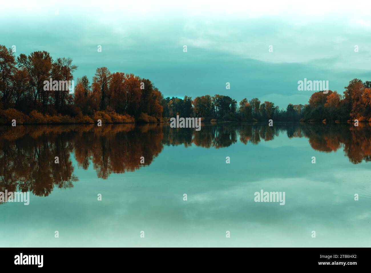 Cold autumn morning on the Willamette River. A reflection of the sky ...