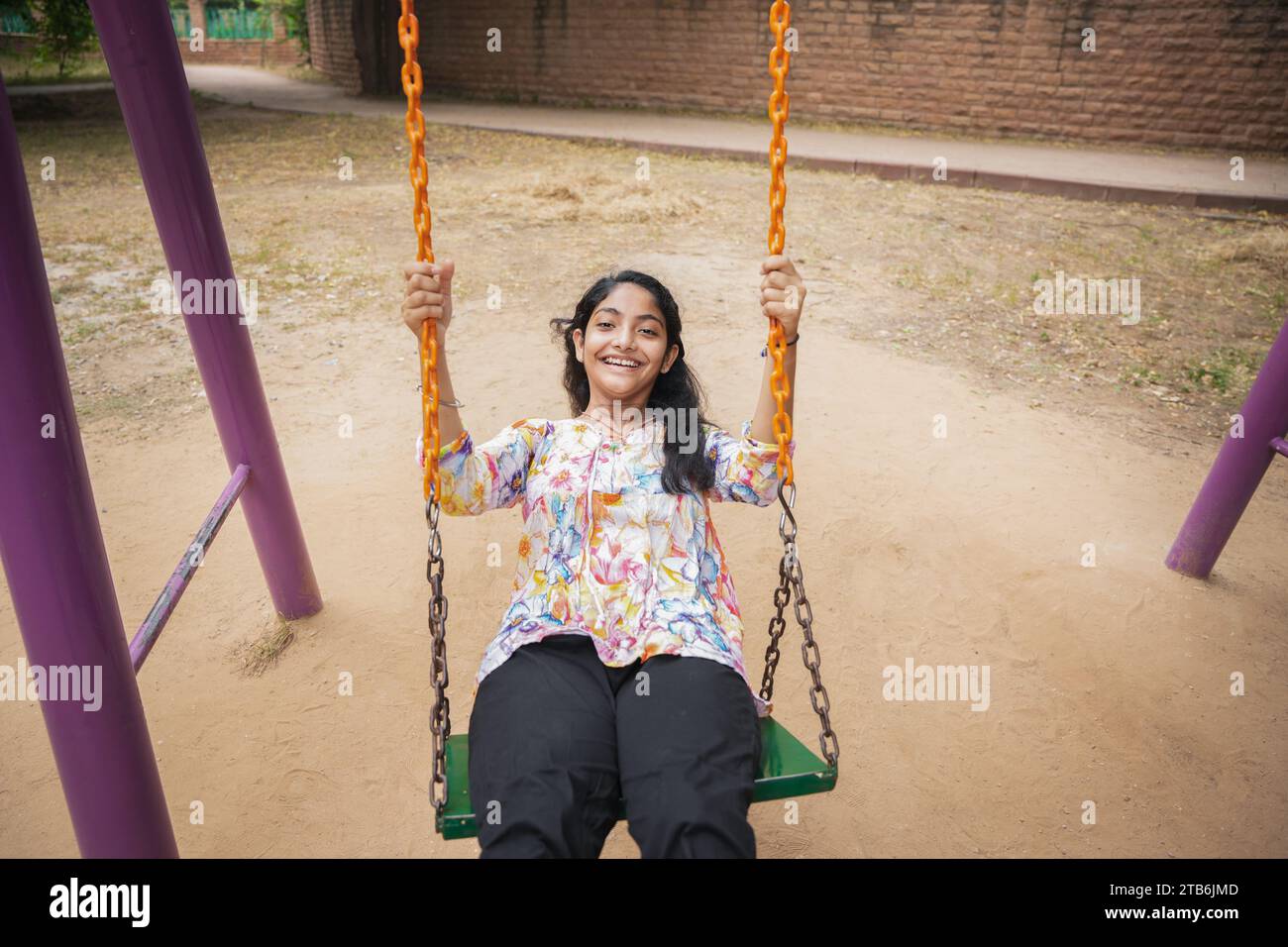 Happy Indian Girl Having Fun On A Swing On Sunny Day Healthy Summer