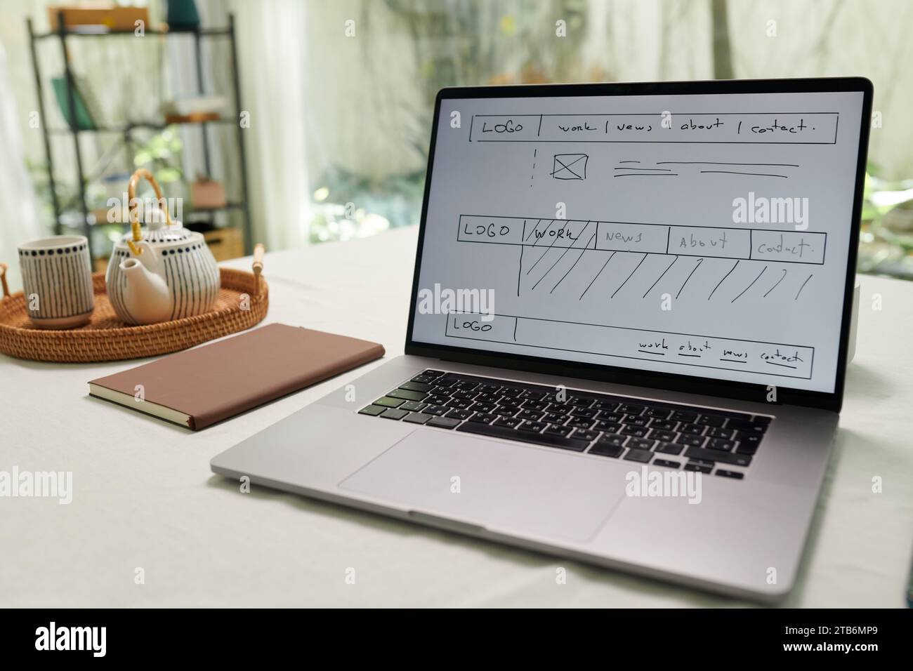 Opened laptop with website wireframe on screen Stock Photo - Alamy