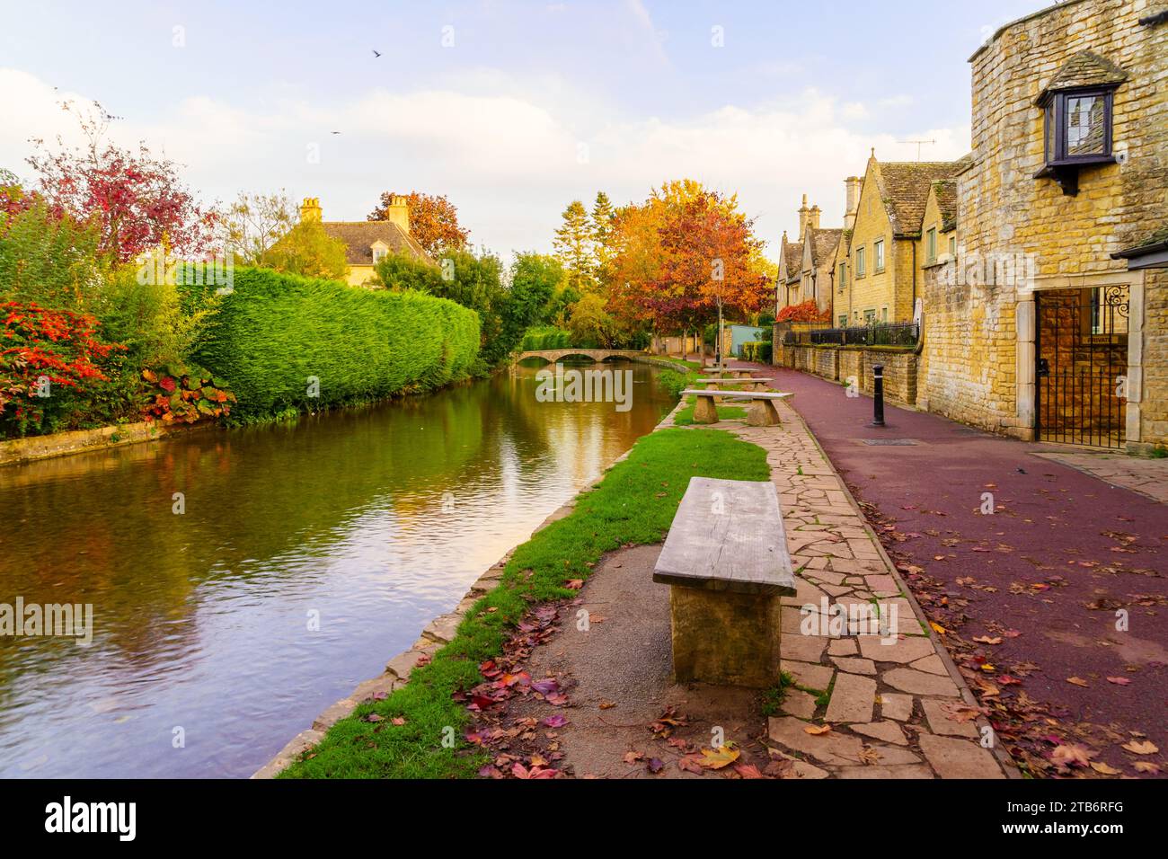 Sunset view of typical houses, and the river Windrush, in the village ...