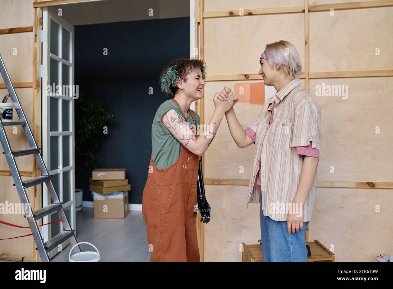 Happy girls shaking hands, they choosing color for their future design ...