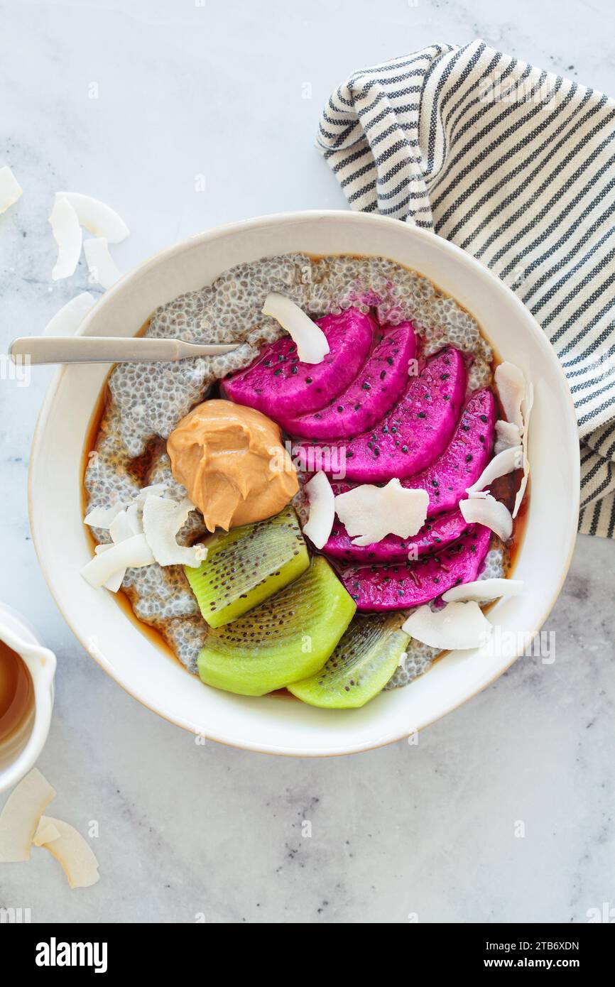Chia pudding with tropical fruits: pittaya, kiwi, coconut chips and ...