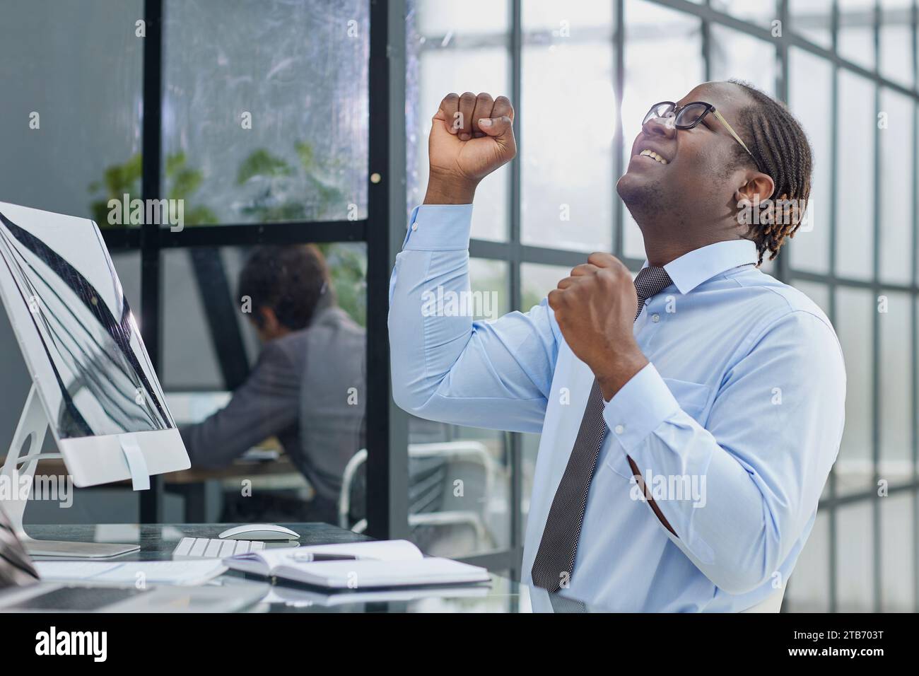 happy man working in the office. raised his hands joyfully Stock Photo ...